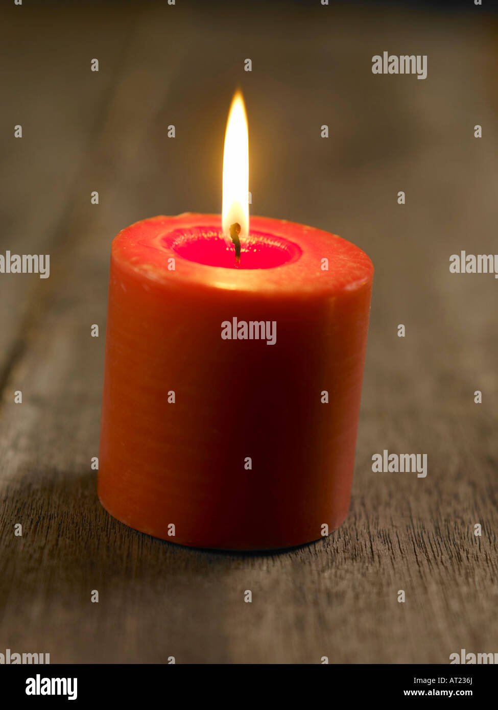 Lit red candle Stock Photo - Alamy