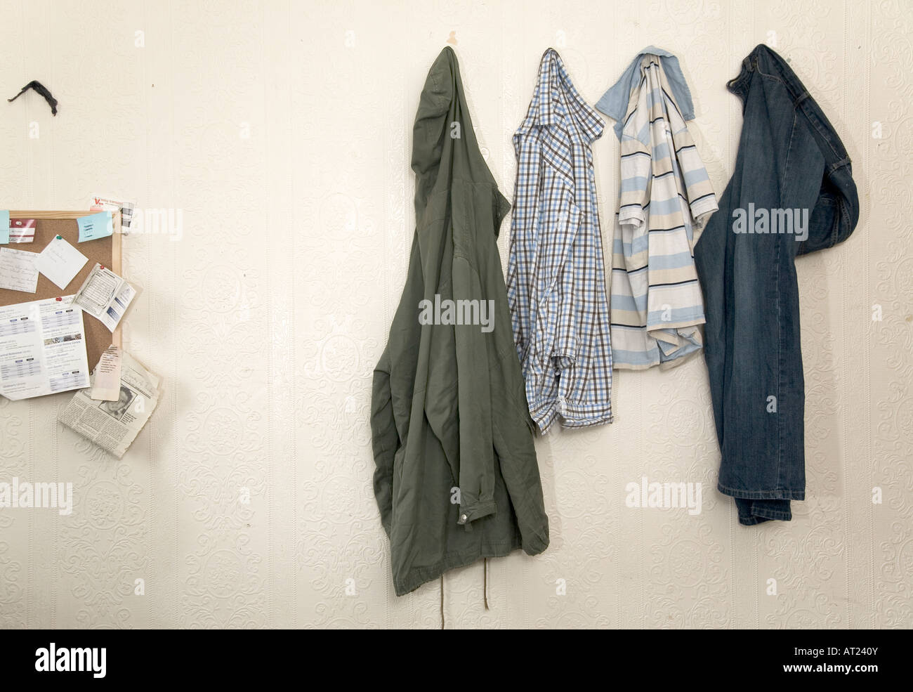 Hanging clothes in mens bedroom Stock Photo - Alamy