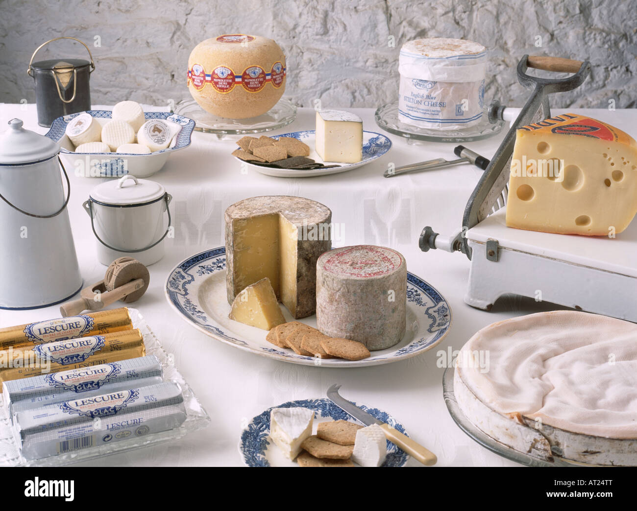 Selection of cheeses on table with cheese slicer Stock Photo - Alamy
