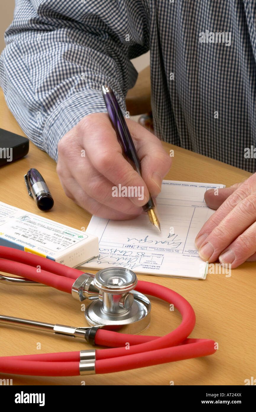 doctor filling out prescription form with pen stethoscope foreground ...