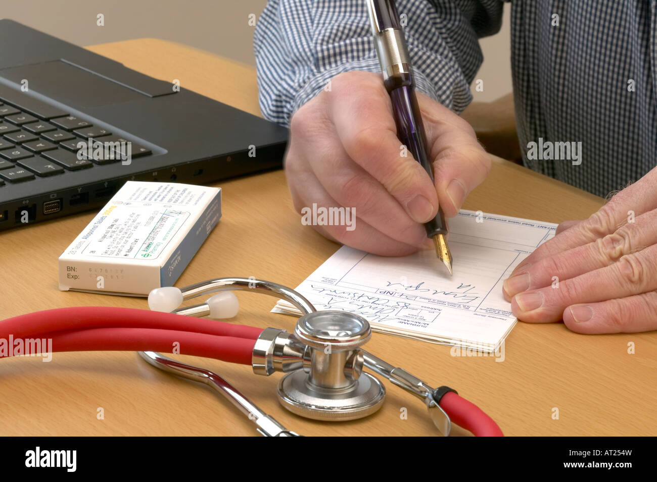 hands filling out prescription form with fountain pen stethoscope ...