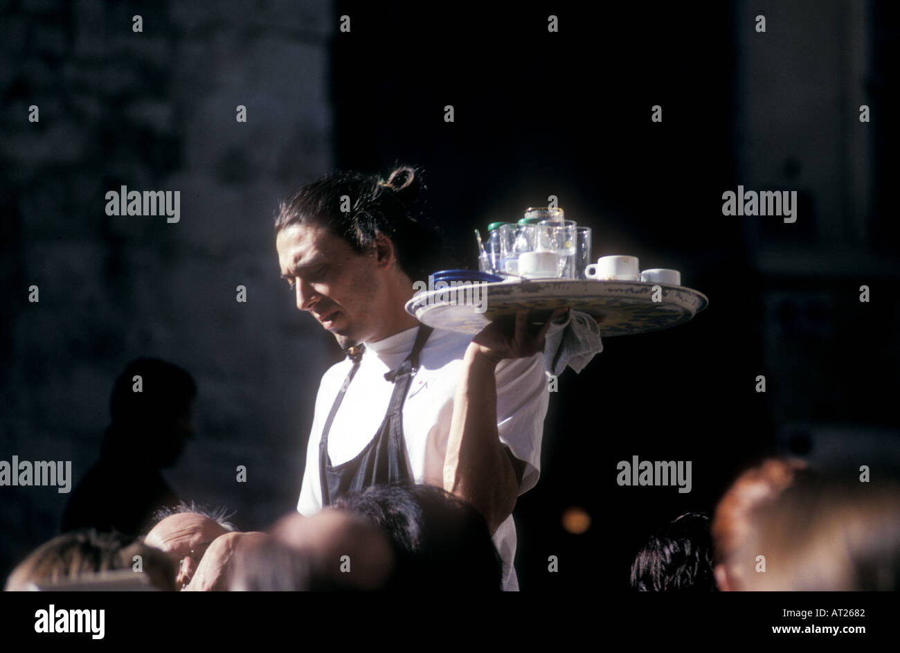 ponytailed young waiter in cafe place de l hotel de ville aix en ...