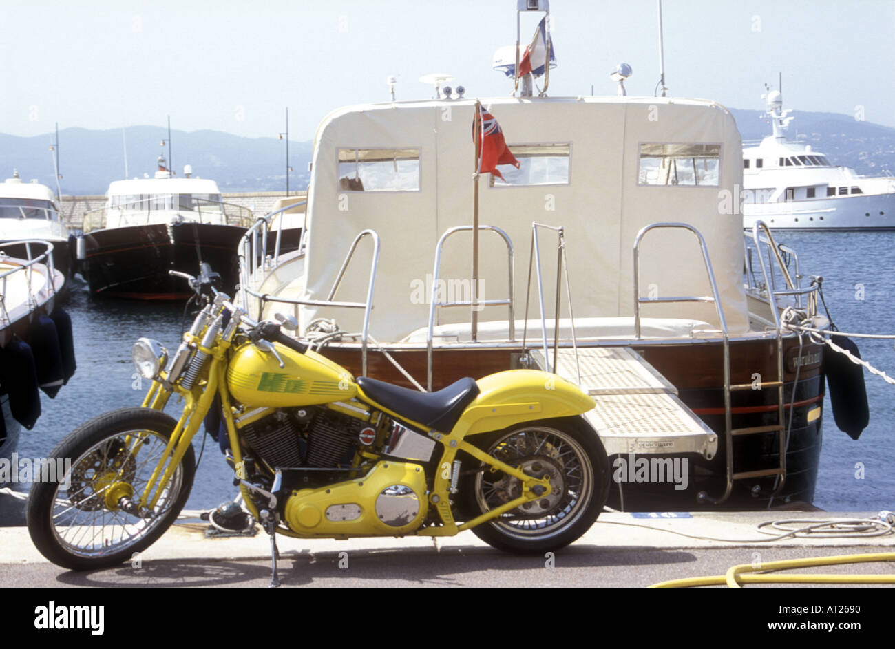 harley davidson motorcycle and apreamare motor yacht on the port of ...