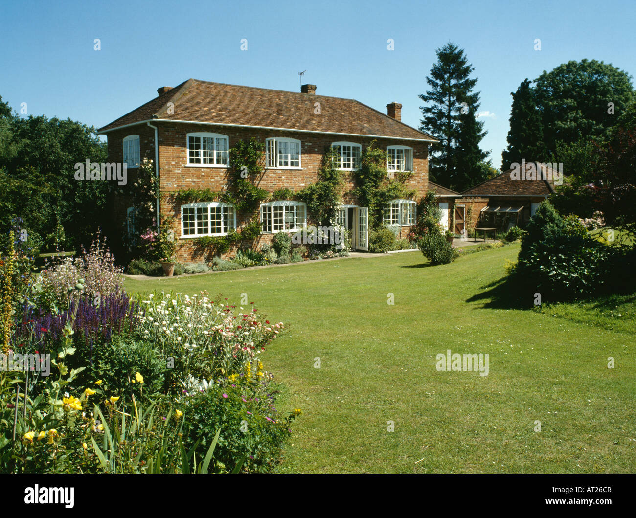 Large lawn in front of traditional country house built in the fifties ...