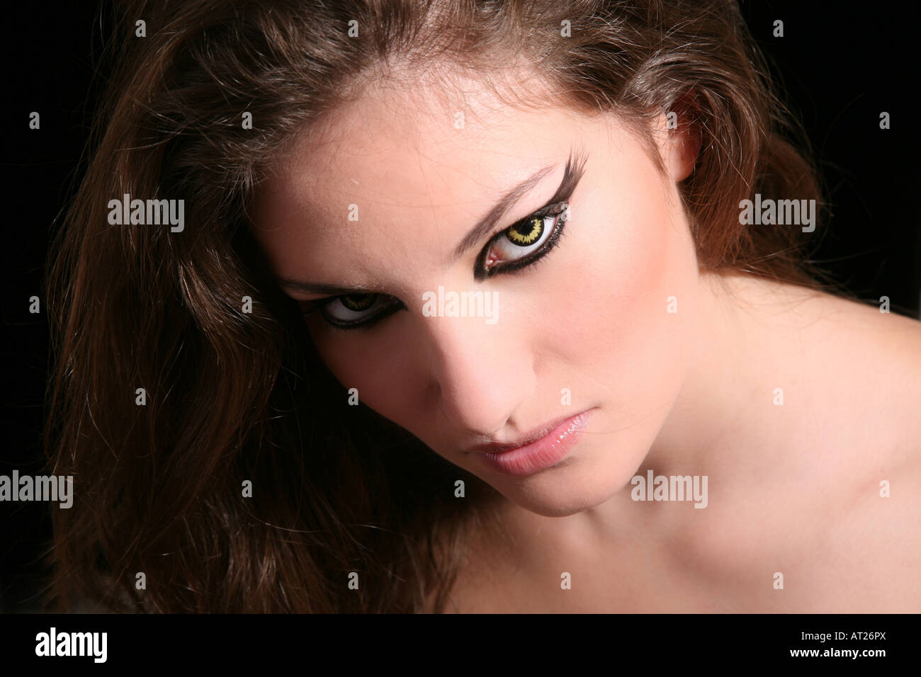 Beautiful brunette looking up with scary eyes Stock Photo - Alamy