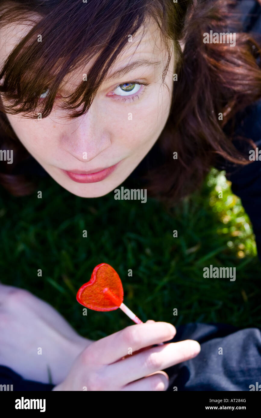 Young woman with red candy in her hands Stock Photo - Alamy