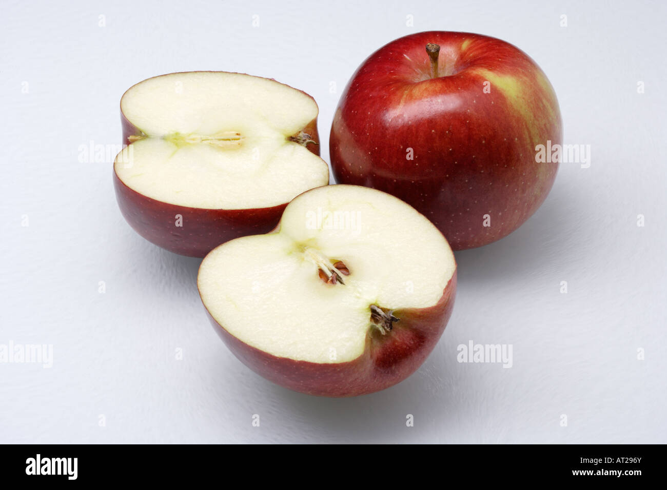 Two red apples, one cut in half Stock Photo - Alamy