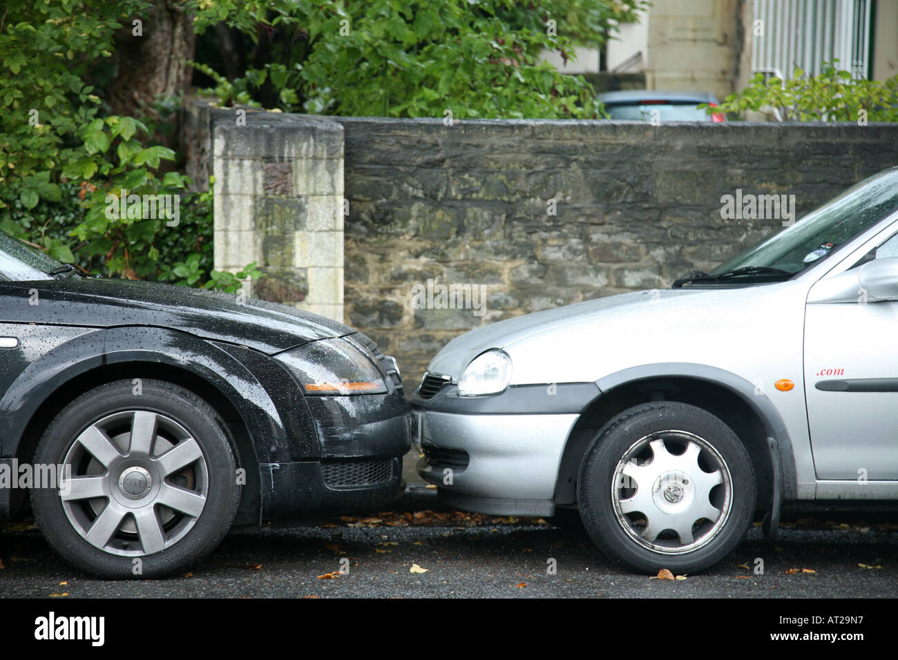 Two very badly parked cars whos bumpers are actually touching This is a ...