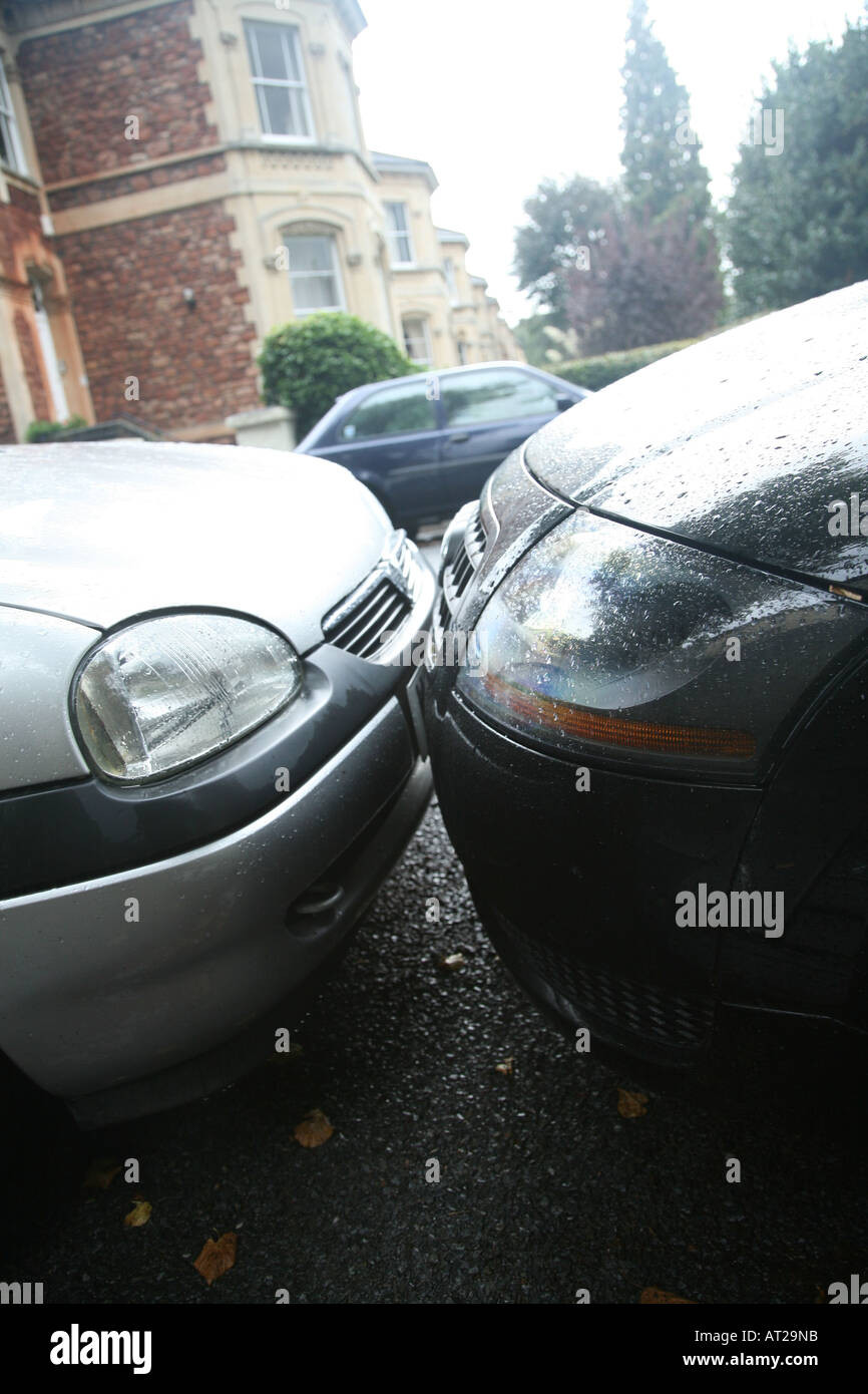 Two cars parked litrally bumper to bumper Their bumpers are touching ...