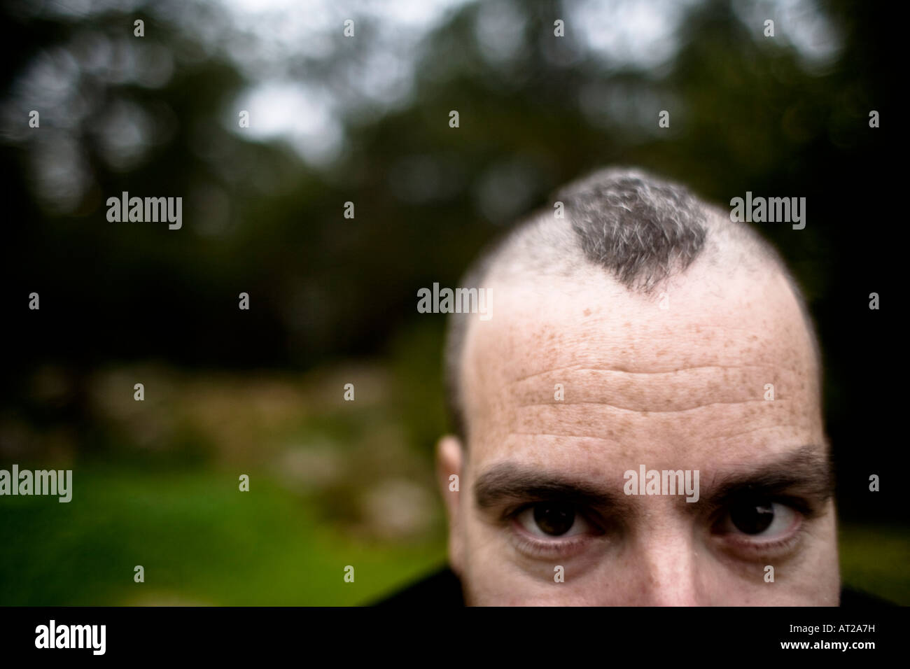 a guy with a Mohawk haircut staring Stock Photo - Alamy