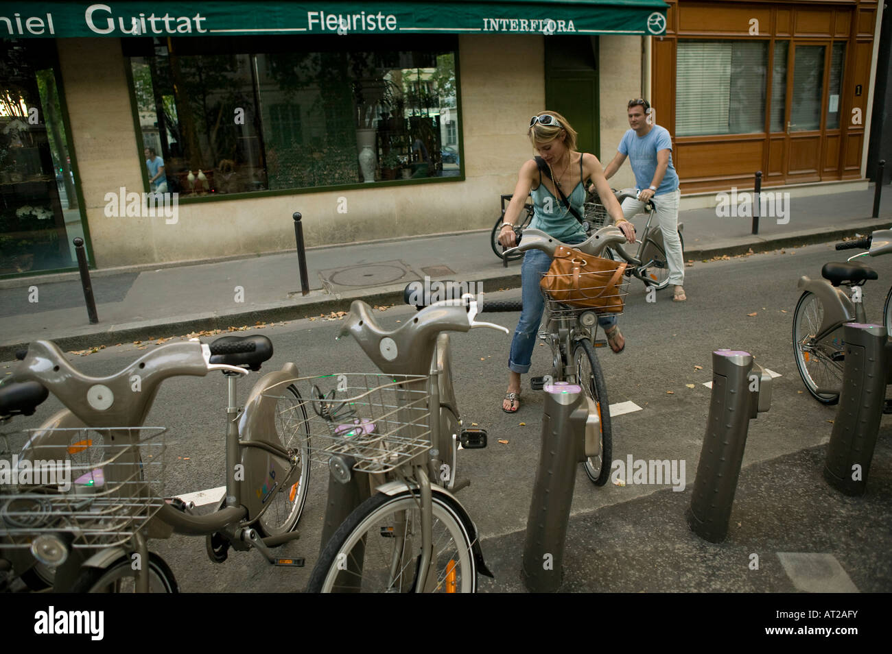 People pick up Velib bicycles from a docking station in Paris France ...
