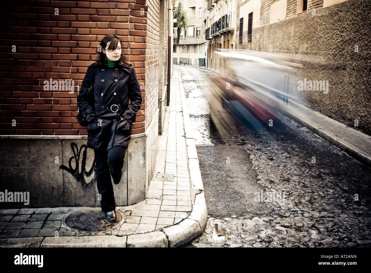 Woman on wall in urban background Stock Photo - Alamy