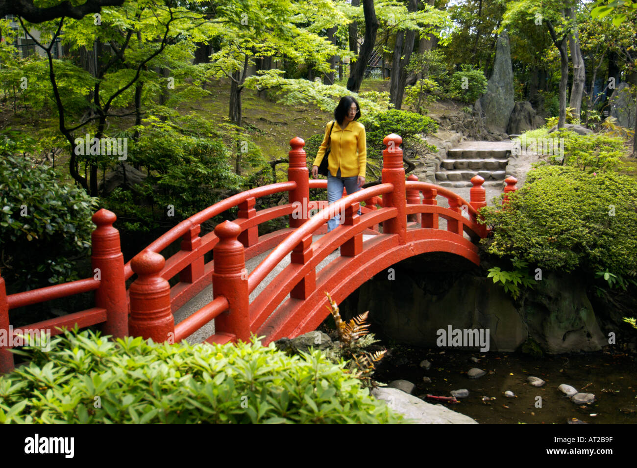 A traditional red wooden bridge in Yasuda Garden in Tokyo Japan 2004 ...