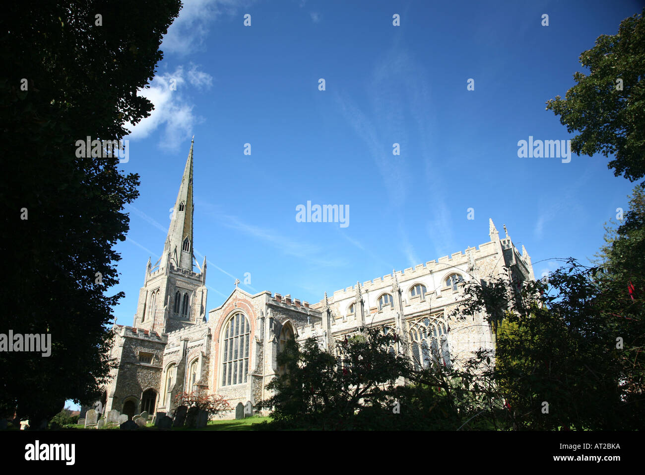 Thaxted Parish Church in Thaxted Essex with a bright blue sky and some ...