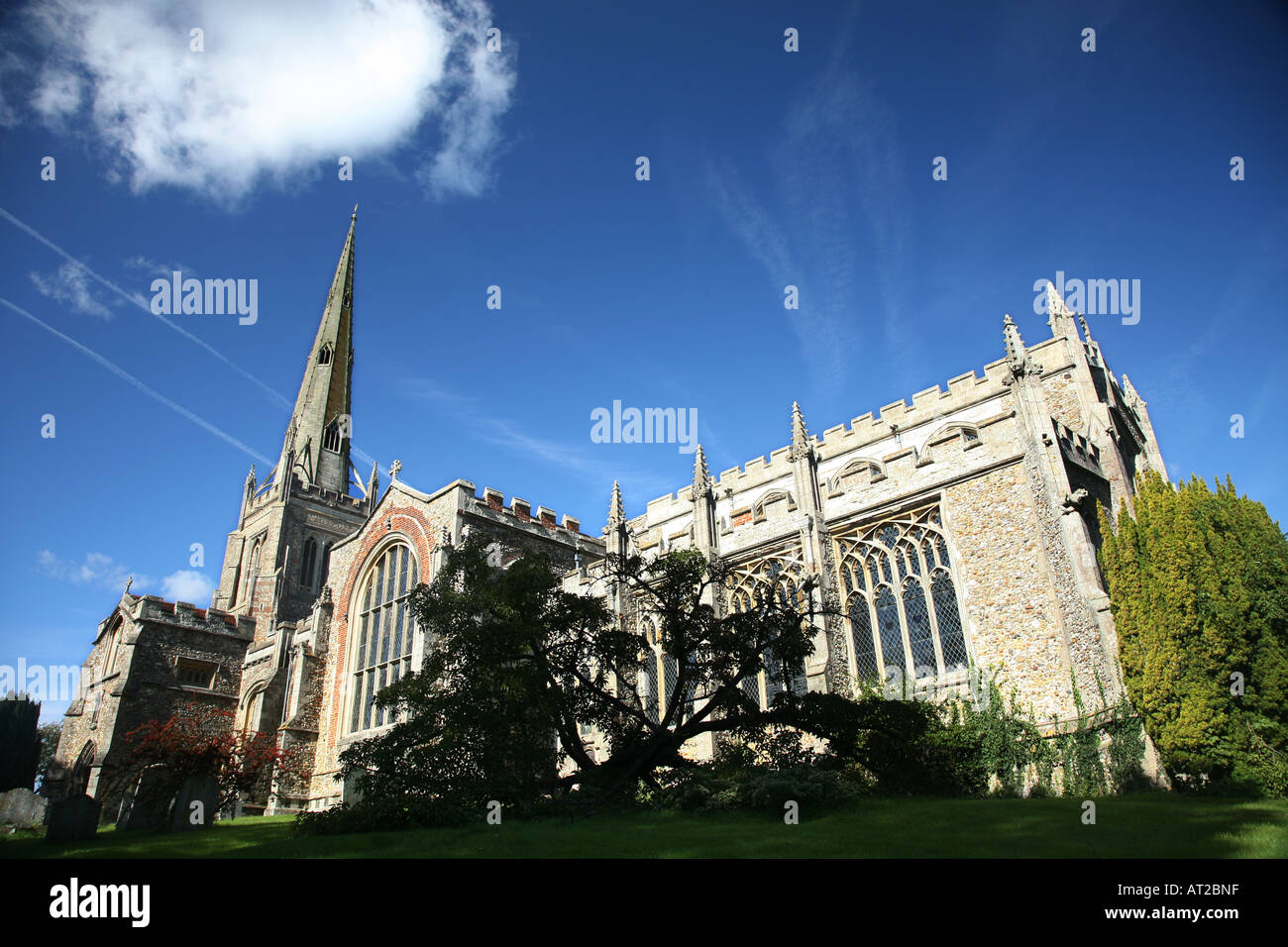 Thaxed Parish Church in Thaxted Essex with a bright blue sky and some ...