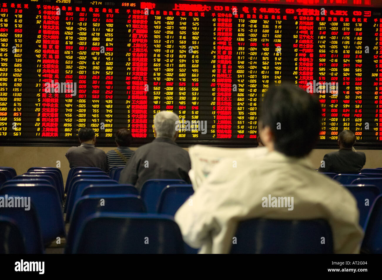 People looking at the stock market prices on a display board Stock ...