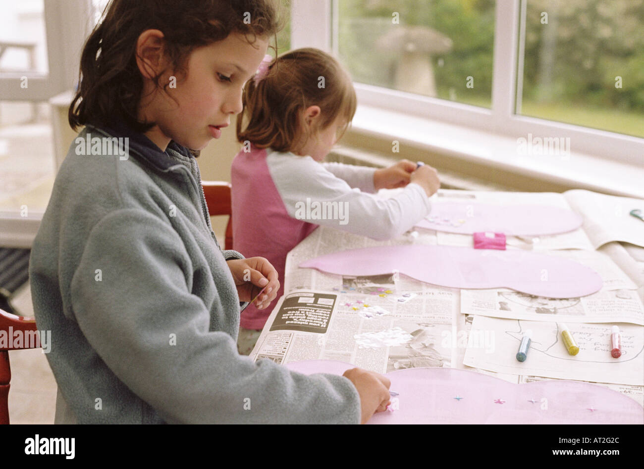 Two girls doing art and crafts Stock Photo - Alamy