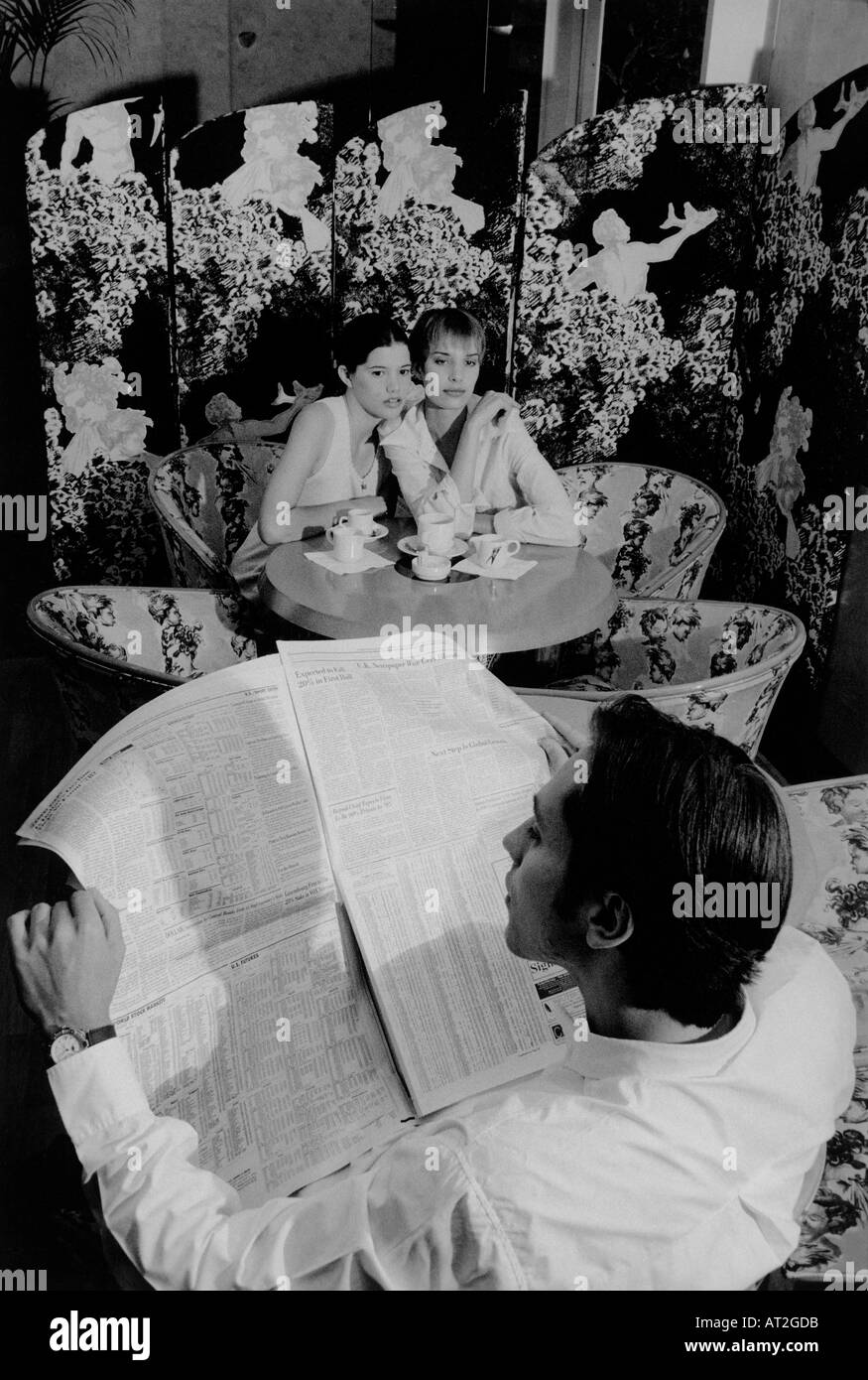 Newspaper reading man table Black and White Stock Photos & Images - Alamy
