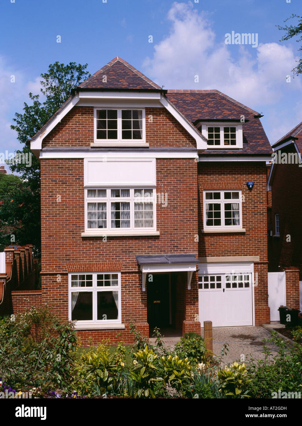Three storey detached newbuild brick house with integral garage Stock ...