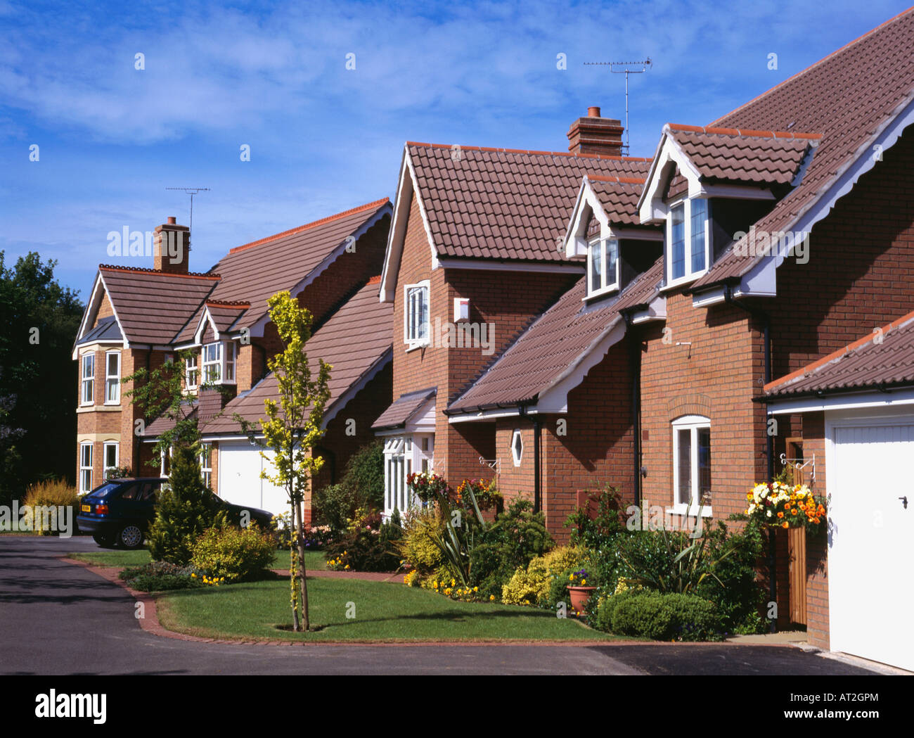 Sideways view of small newbuild detached brick houses Stock Photo - Alamy