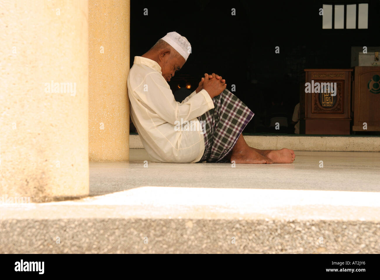 Muslim man dozing in the entrance to Kuching Mosque, Kuching, Sarawak ...