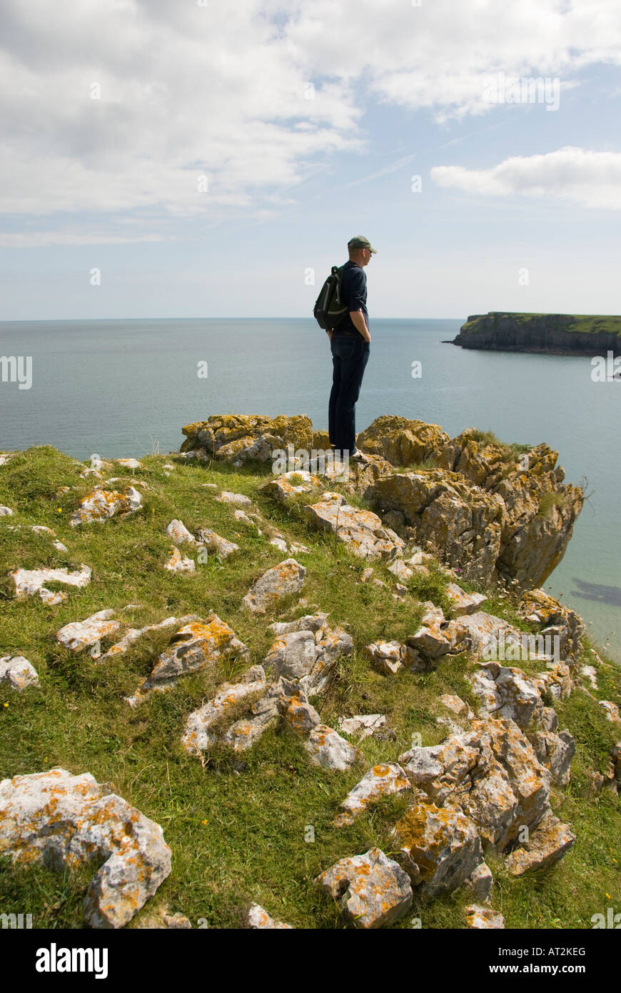 Hiker on top of a cliff taking in the scenery Stock Photo - Alamy