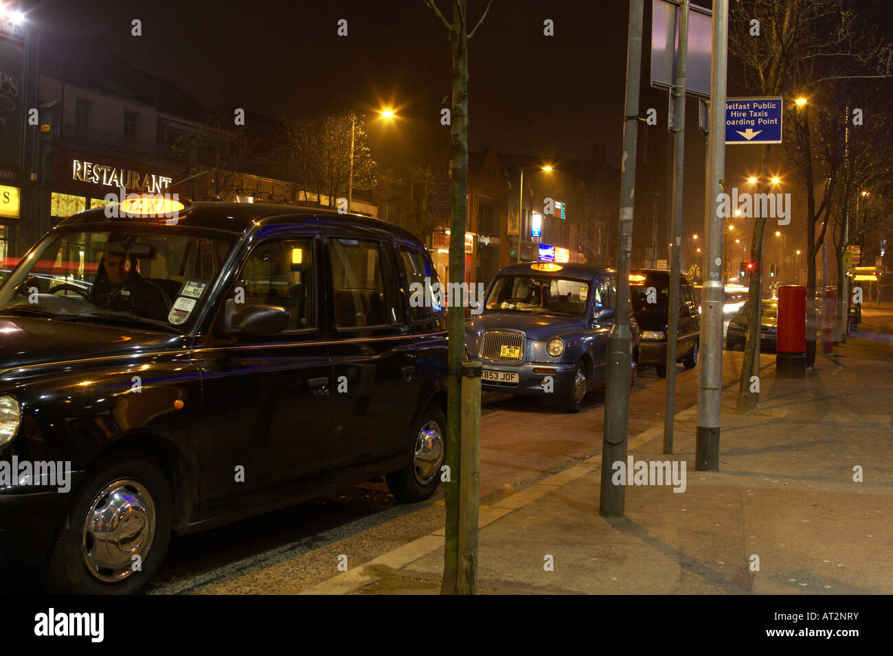 taxis and cabs waiting on street cab rank for passengers in pub and ...
