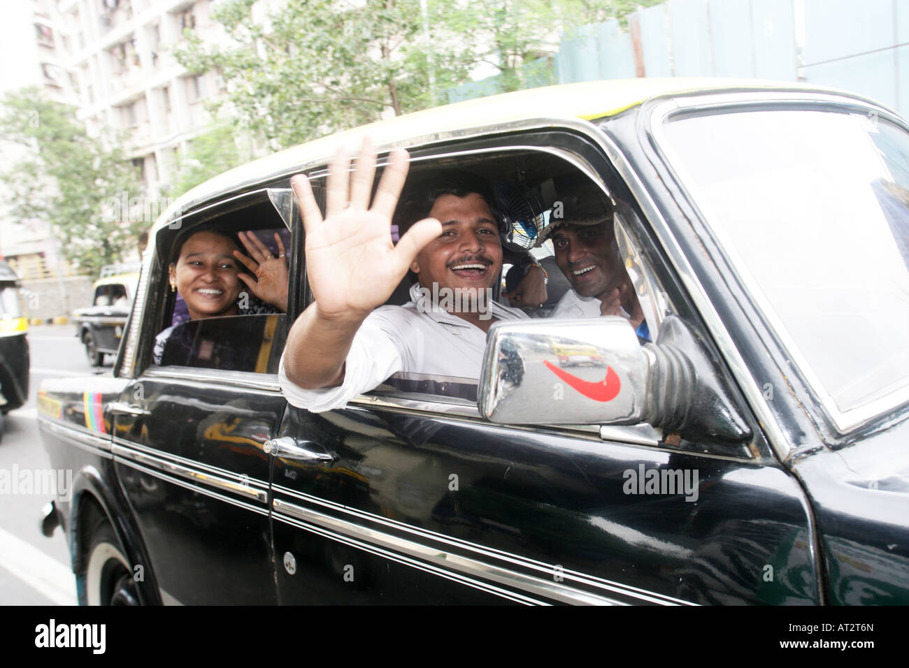 a taxi driver in bombay mumbai waves to the camera Stock Photo - Alamy