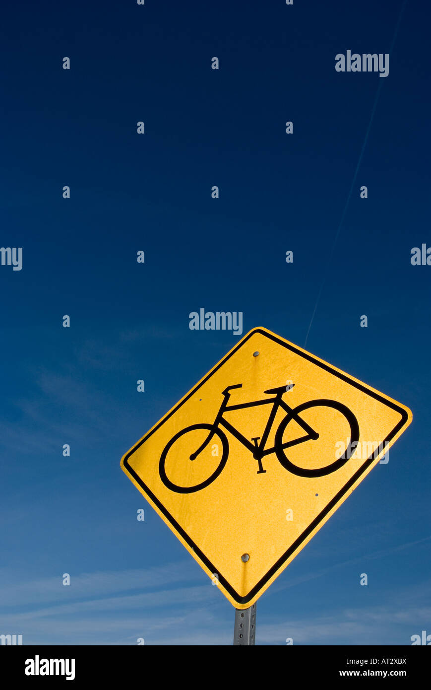 Bicycle crossing sign against a blue sky Stock Photo - Alamy