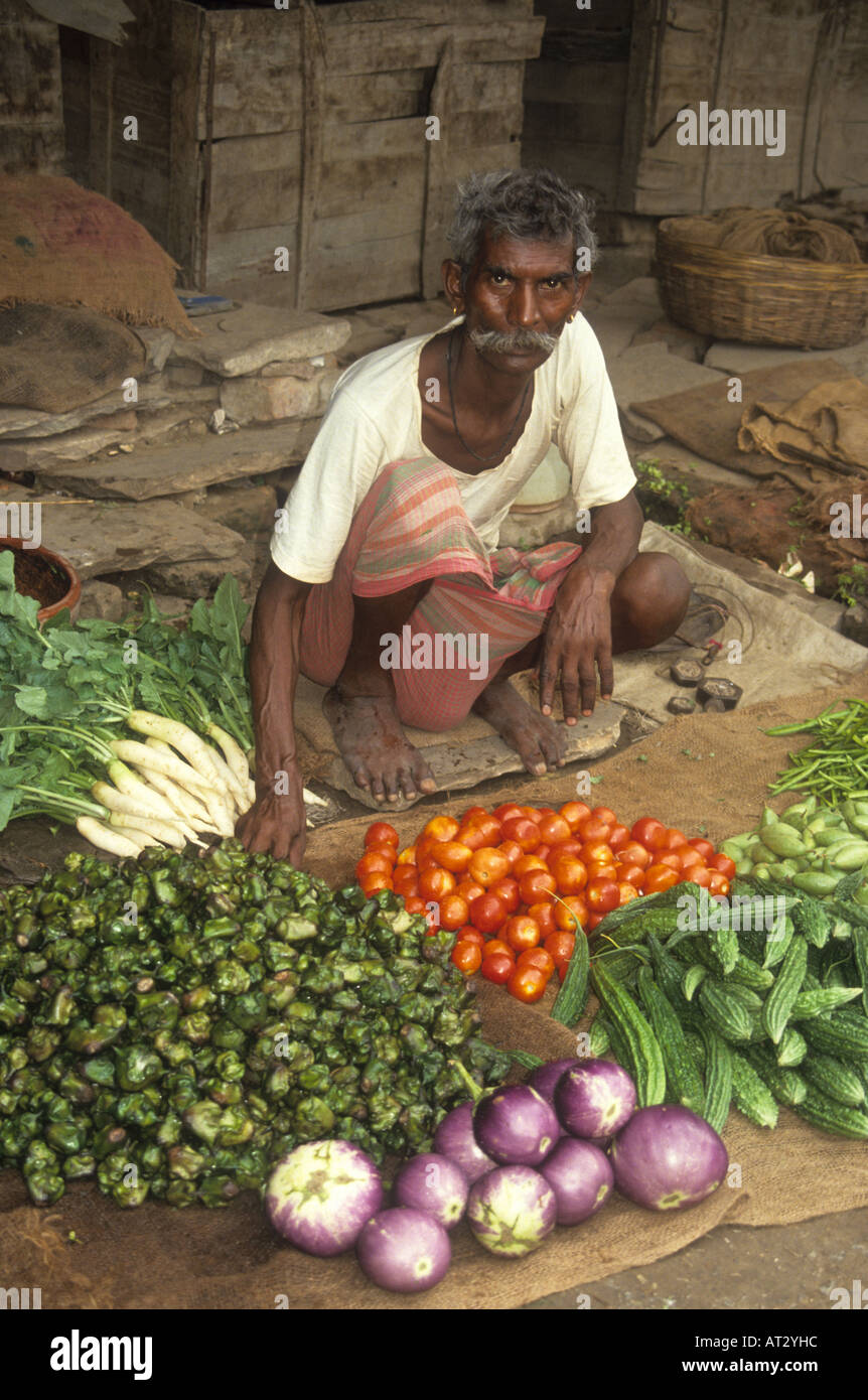 Local man selling vegetables in the market at the holy city Varanasi ...