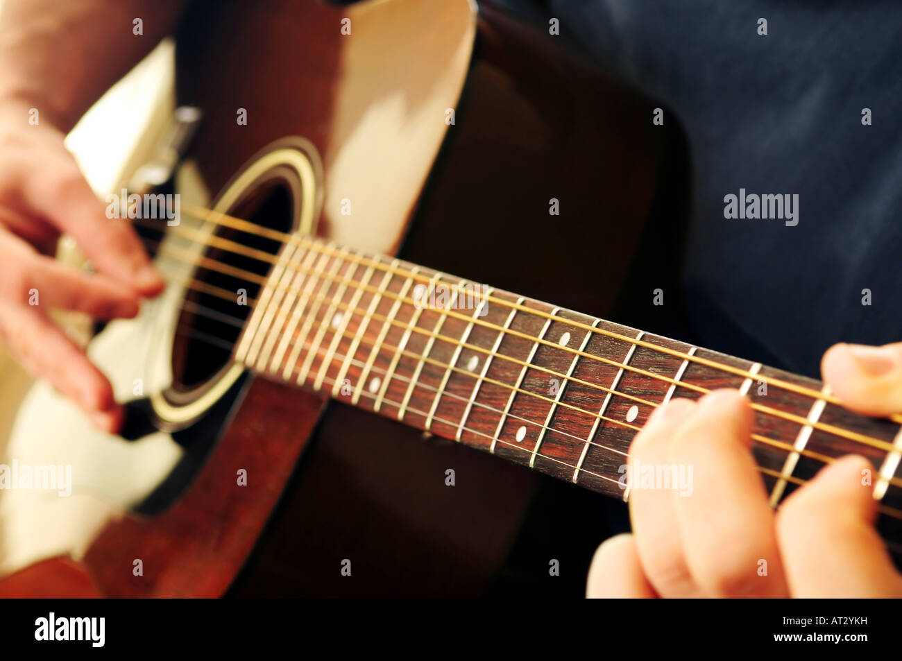 Hands of a person playing an acoustic guitar Stock Photo - Alamy
