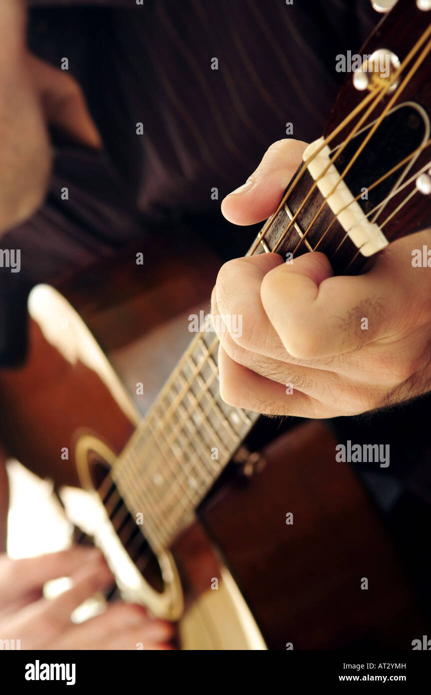 Man playing a musical instrument acoustic guitar Stock Photo - Alamy