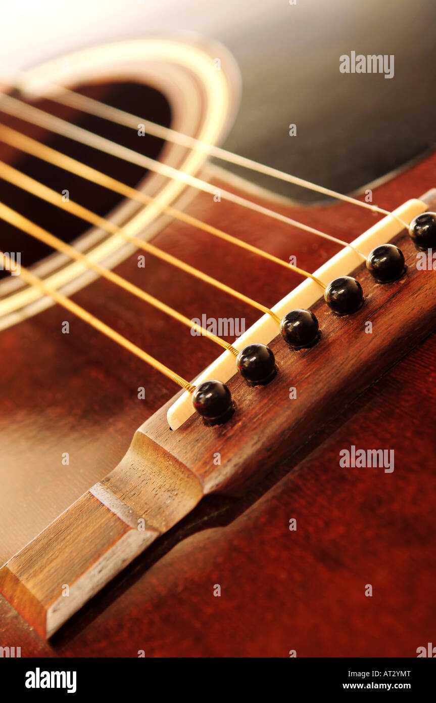 Acoustic guitar bridge and strings close up Stock Photo - Alamy