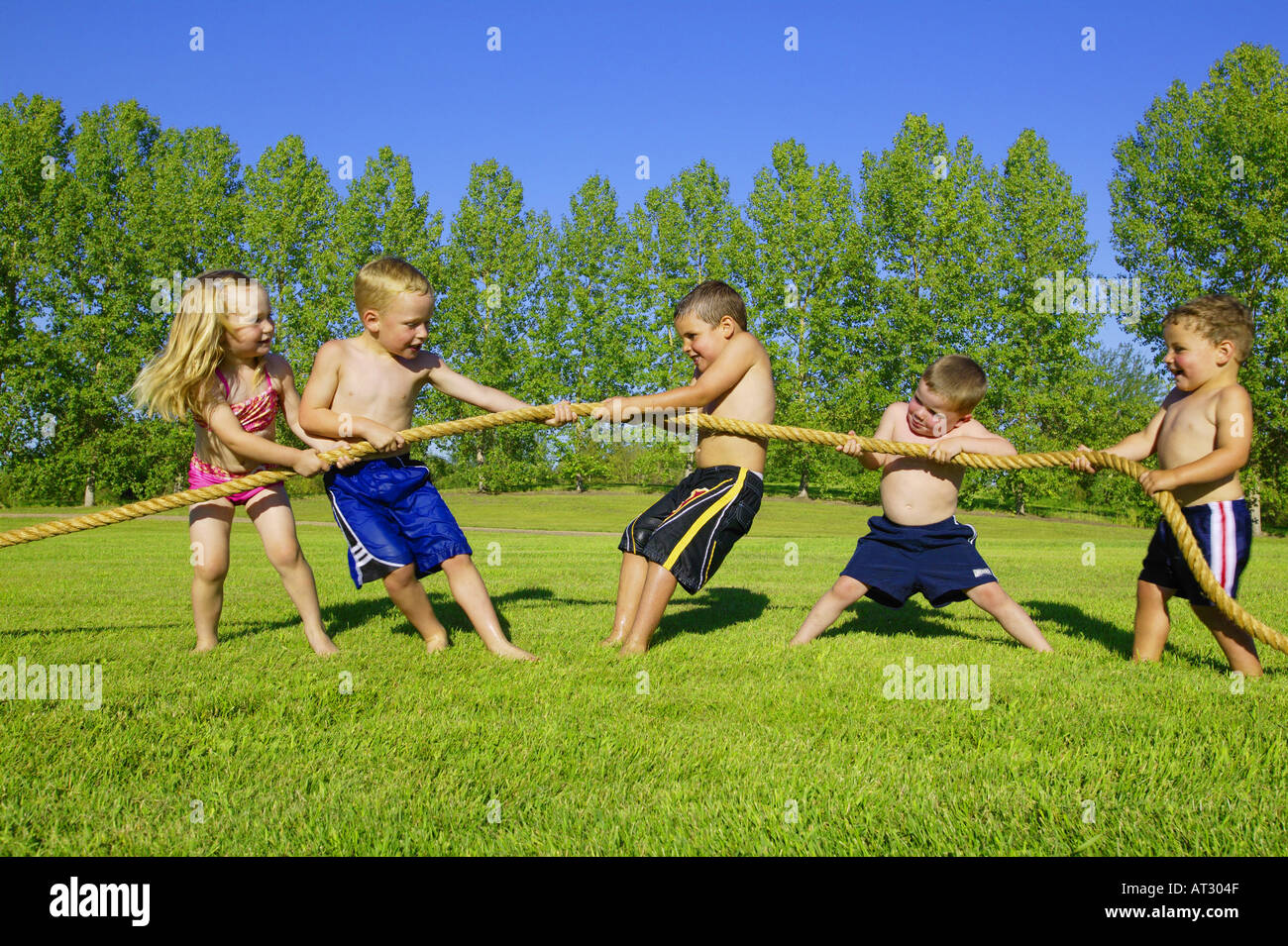 A group of children play tug of war Stock Photo - Alamy