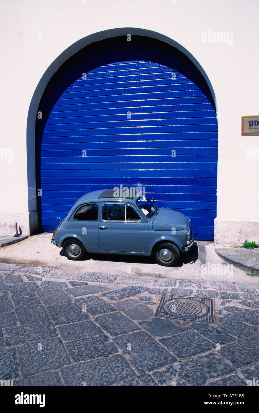 European travel in Amalfi Italy small car and blue garage door Stock ...