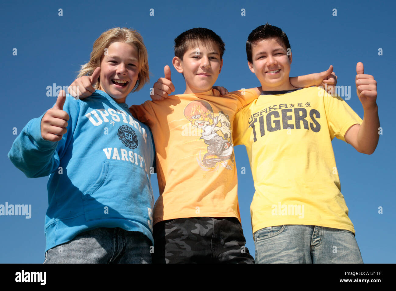 three teenage boys looking into the camera with their thumbs up Stock ...