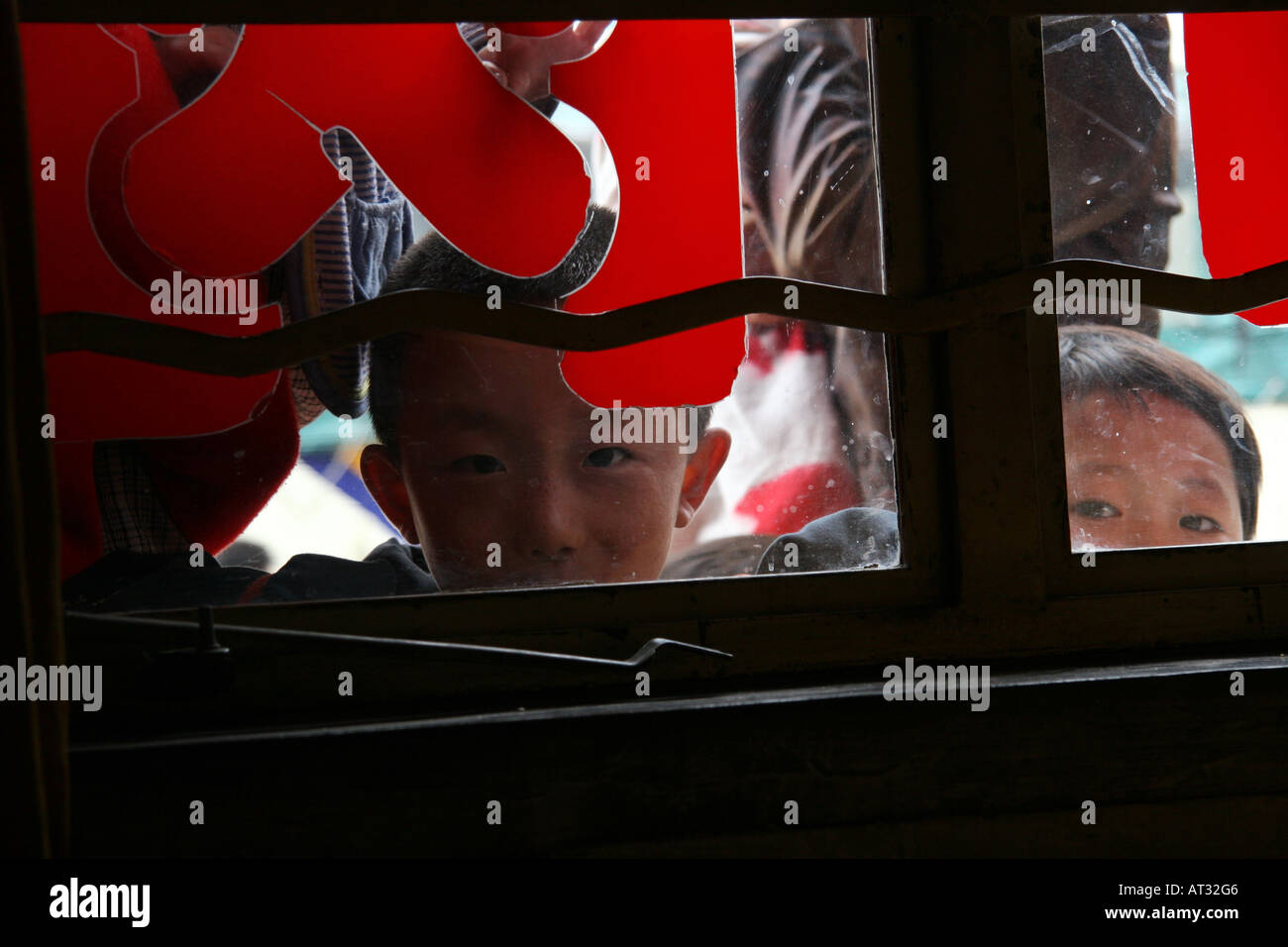 Kids peering in through the window of a village 'cafe' in the district ...