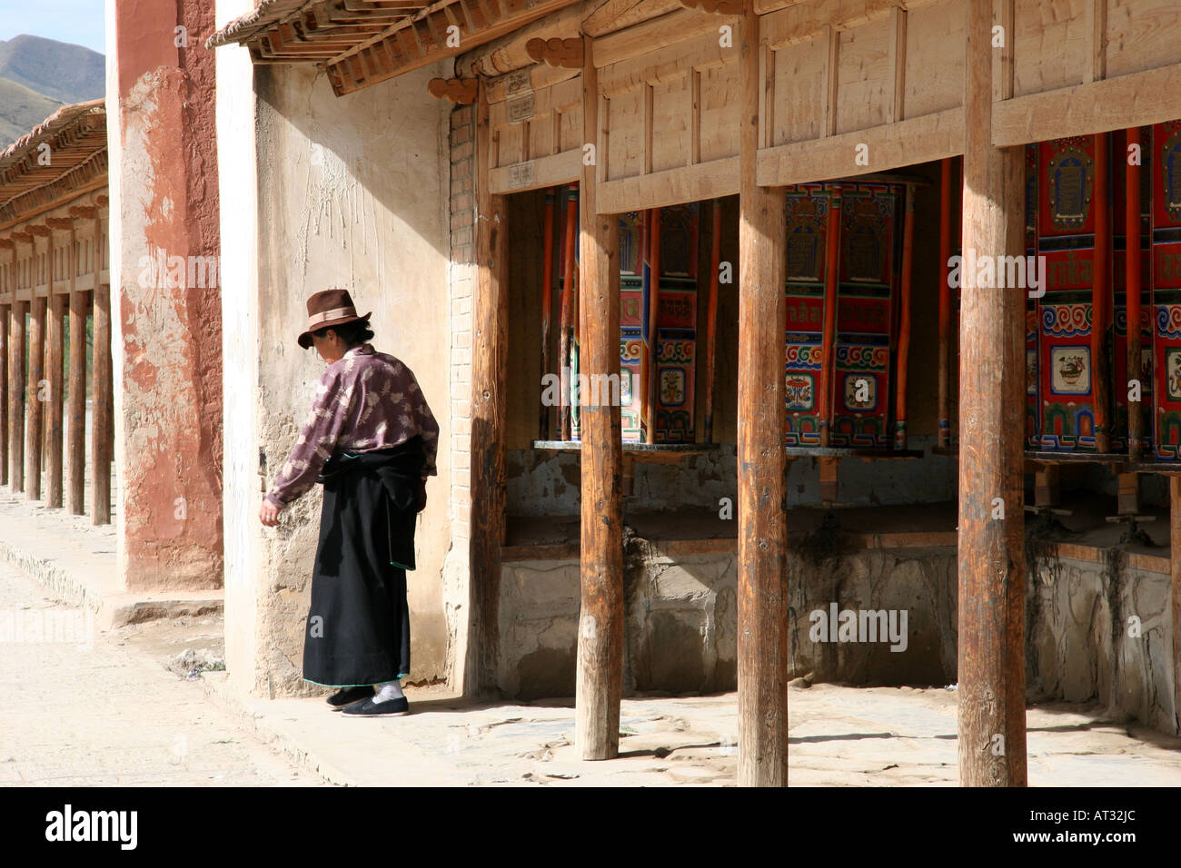 Pilgrim spinning prayer wheels on the pilgrim circuit at the famed ...