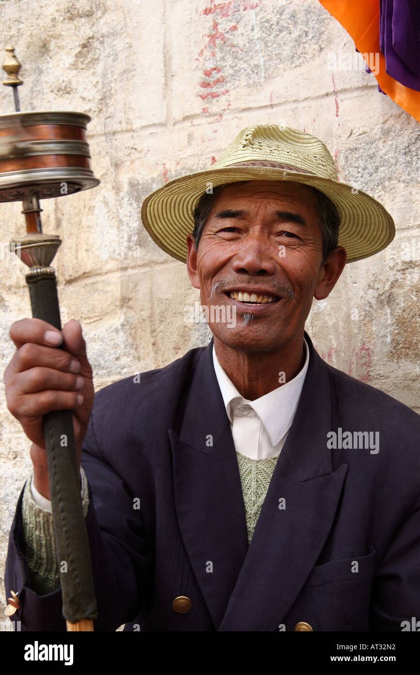 Pilgrim spinning his prayer wheel on the Barkhor pilgrim circuit ...