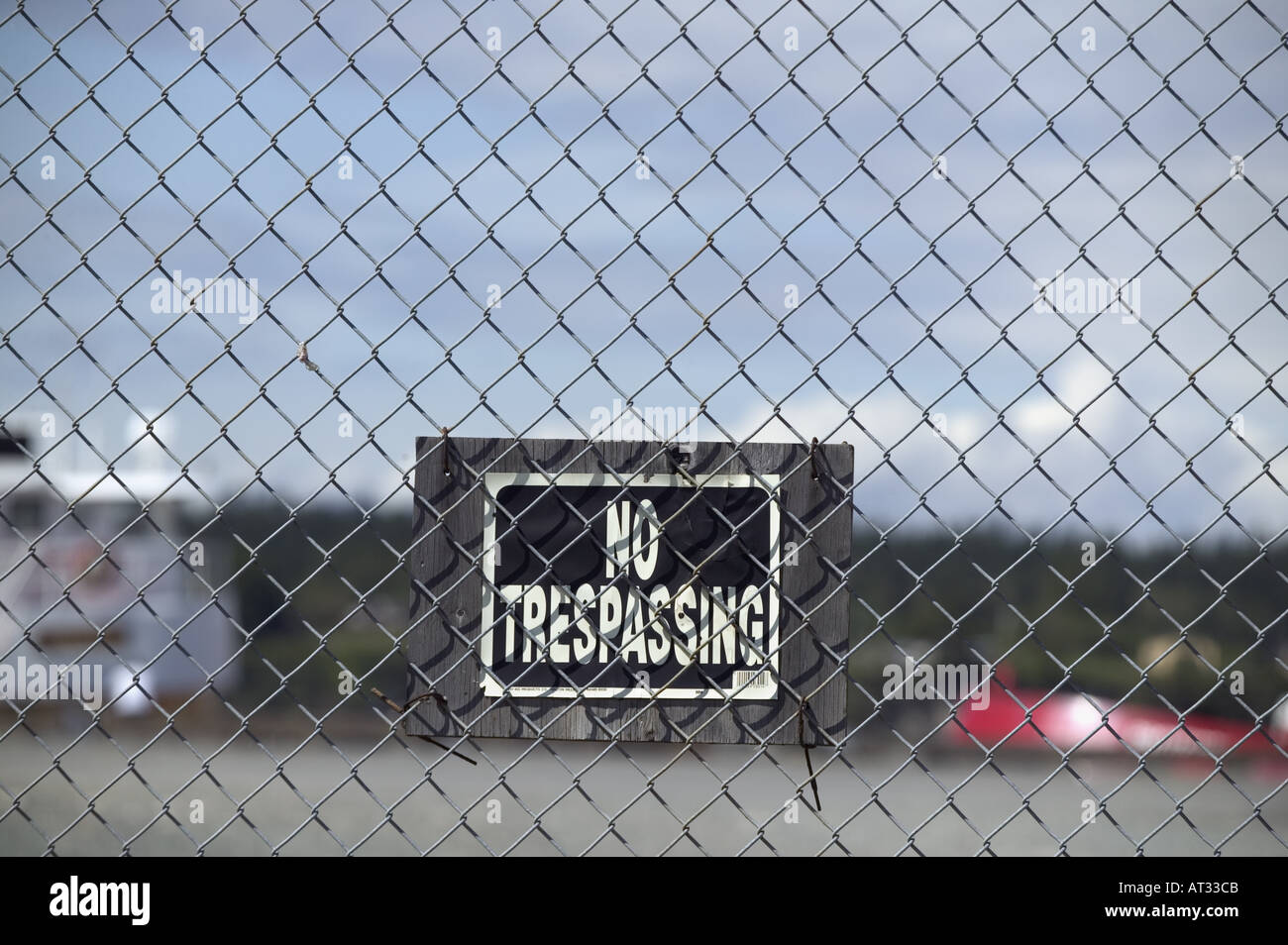 No Trespassing sign on chain link fence Stock Photo - Alamy