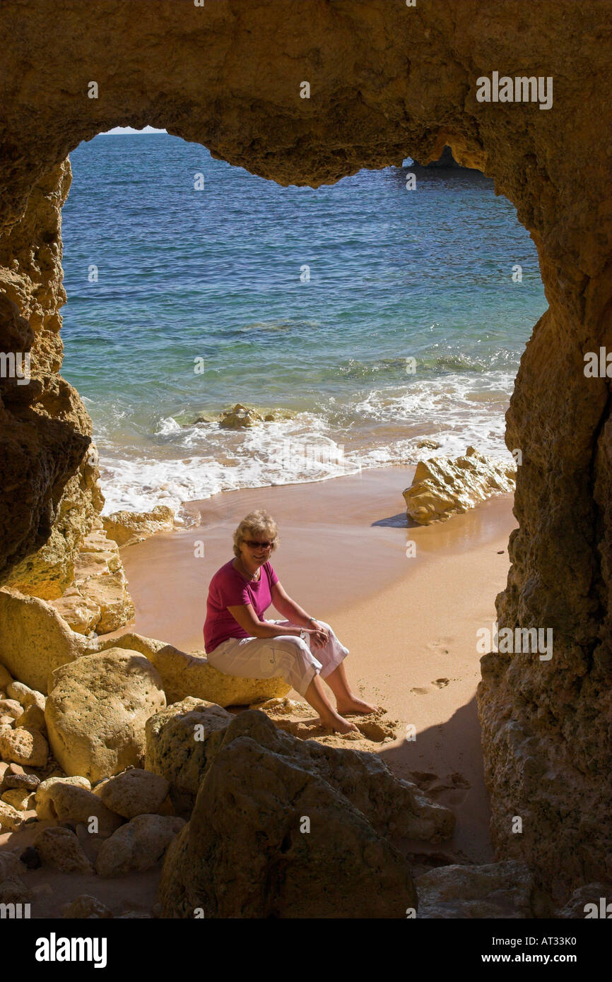 Single woman sitting on beach Stock Photo - Alamy