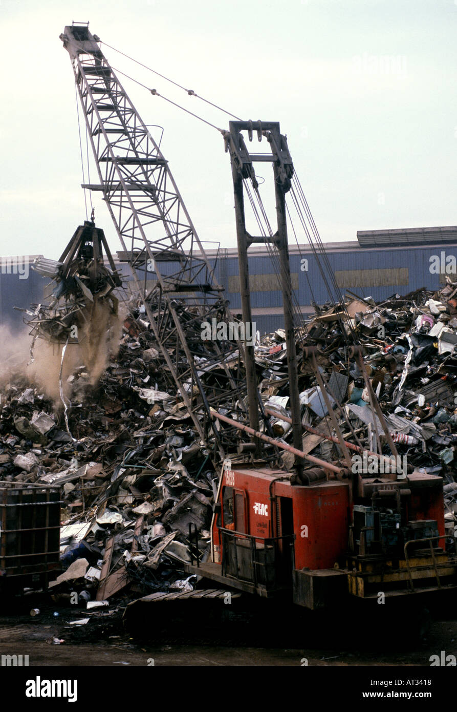 Crane lifting scrap iron at steel manufacturing plant in the industrial ...
