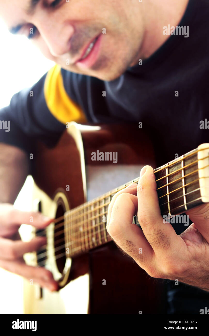 Man playing a musical instrument acoustic guitar Stock Photo - Alamy