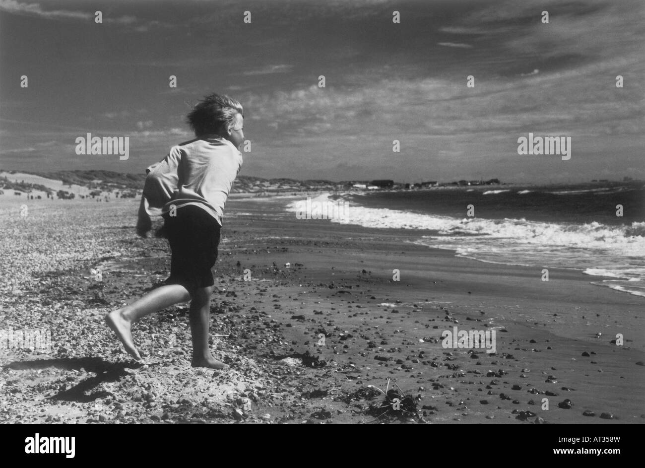 Boy Throwing Pebbles Into The Sea High Resolution Stock Photography and ...