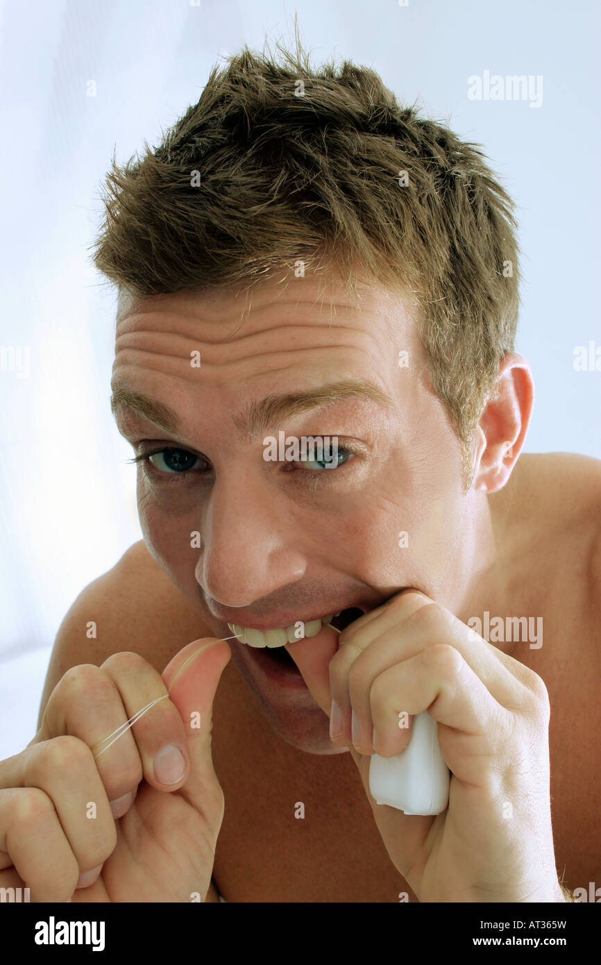 A man flossing his teeth Stock Photo - Alamy