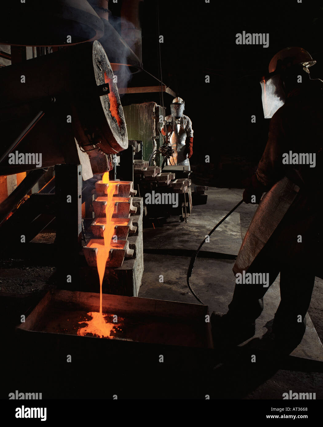 Operators casting bullion by pouring molten gold into four 28 kg ingots ...