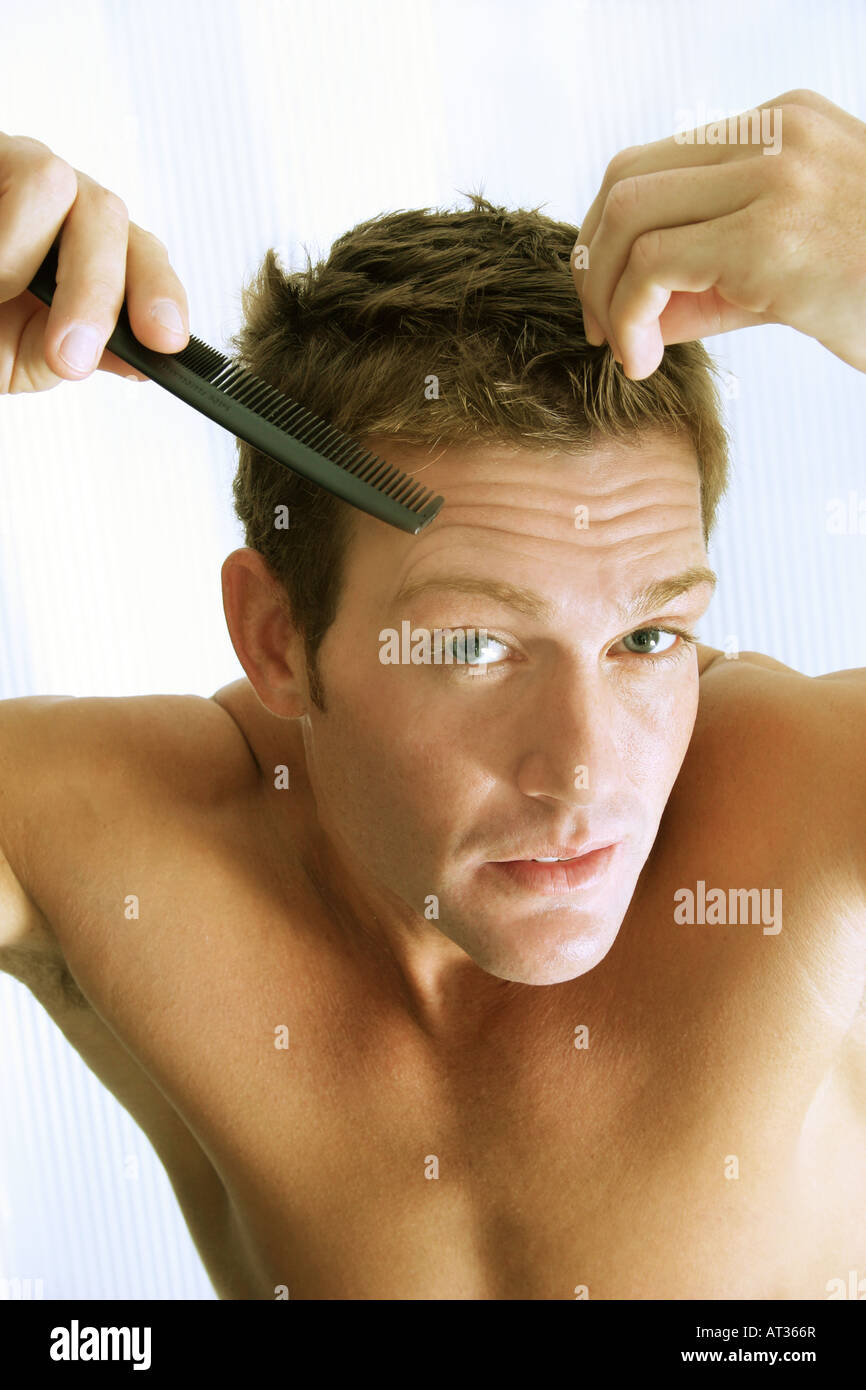 A man combing his hair Stock Photo - Alamy