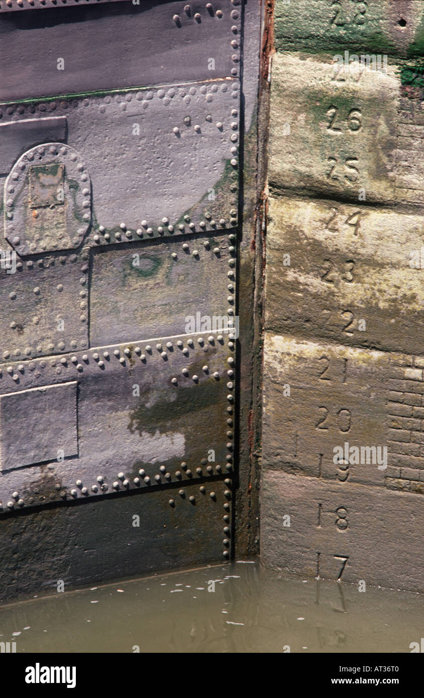 Riveted and welded plate of lock gates on tidal River Thames with water ...