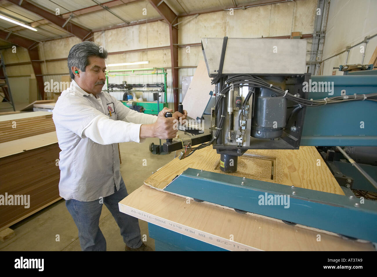 Man working on door manufacturing Stock Photo - Alamy