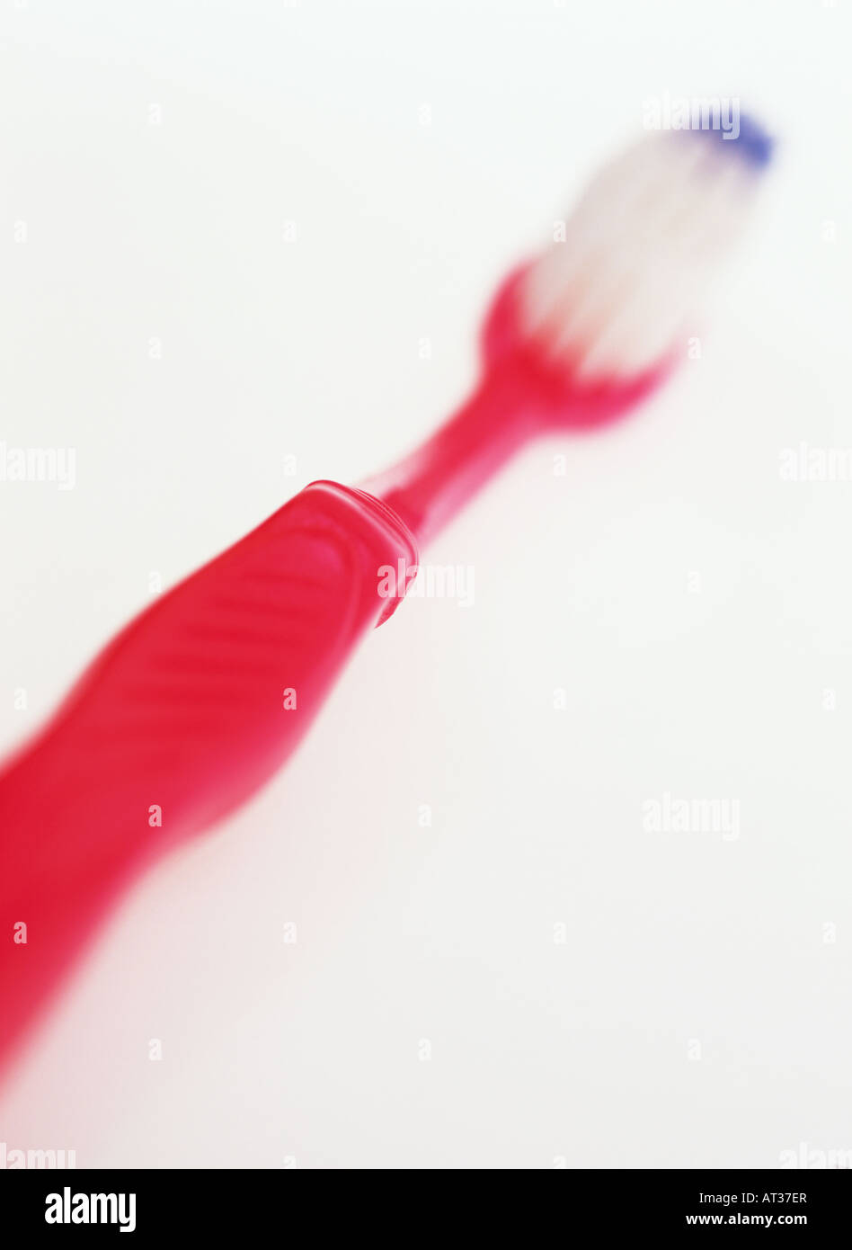 A red toothbrush, white background Stock Photo - Alamy